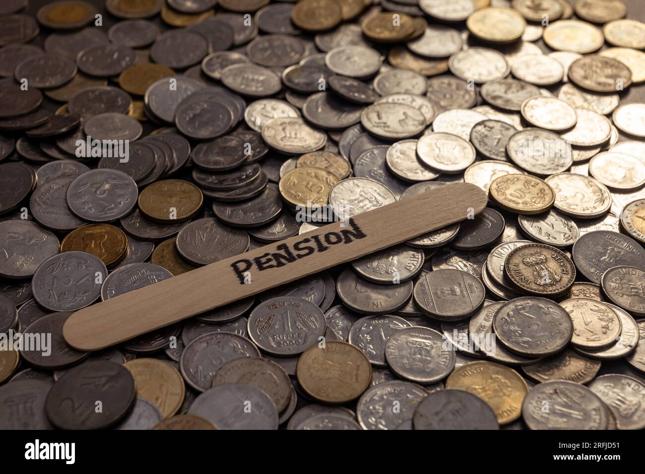 This stock image shows a pile of Indian rupee coins spread on a table ...