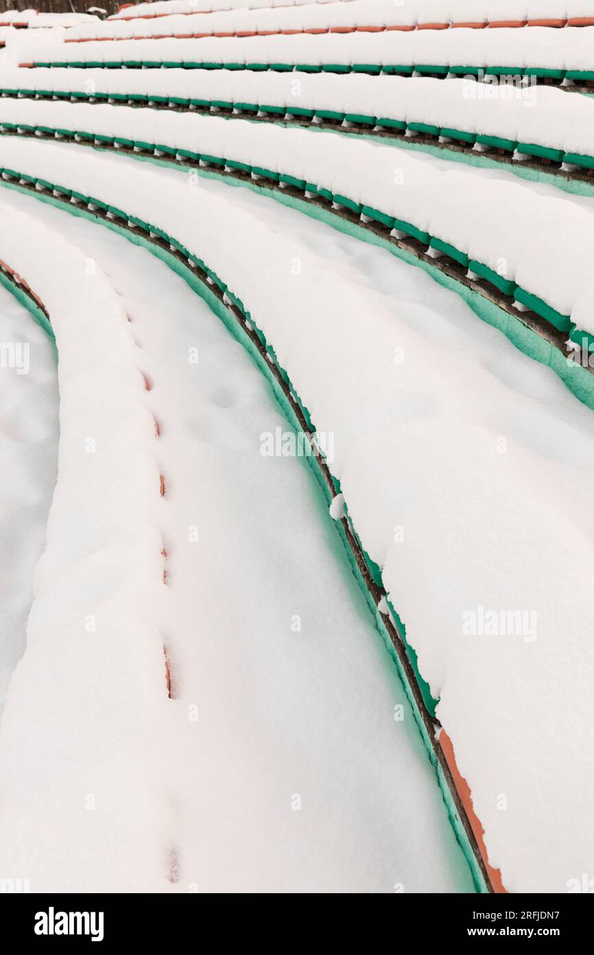 stadium seats covered with snow in winter, stadium and stadium seats in ...