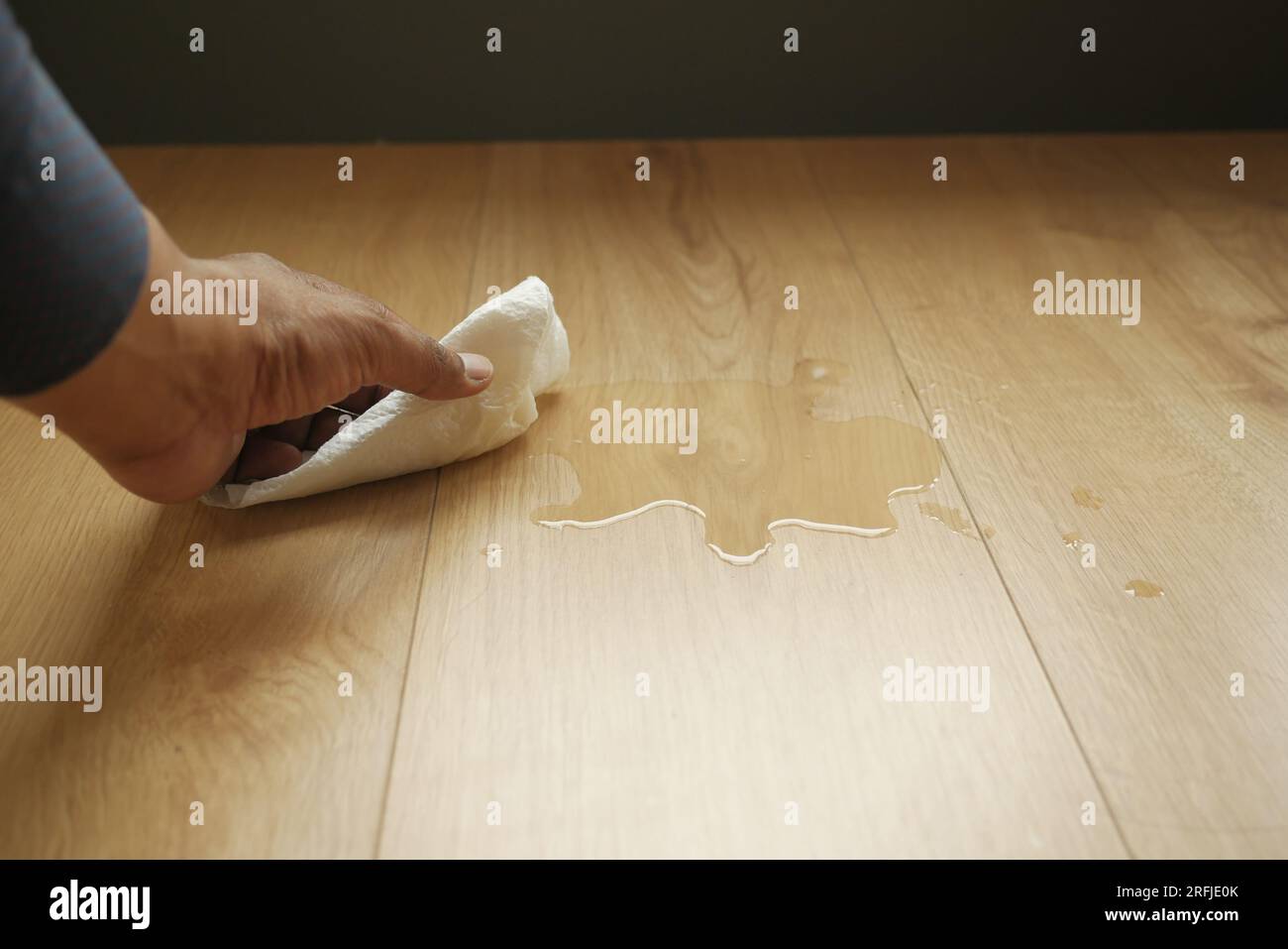 A man's hand washing the floor with a tissue Stock Photo - Alamy
