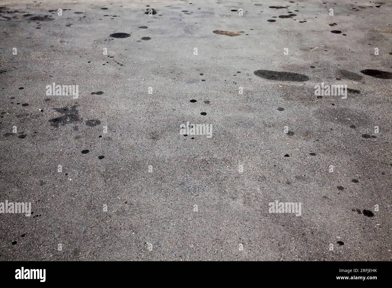 car oil stains on an asphalt road, stains from engine oil flowing out ...