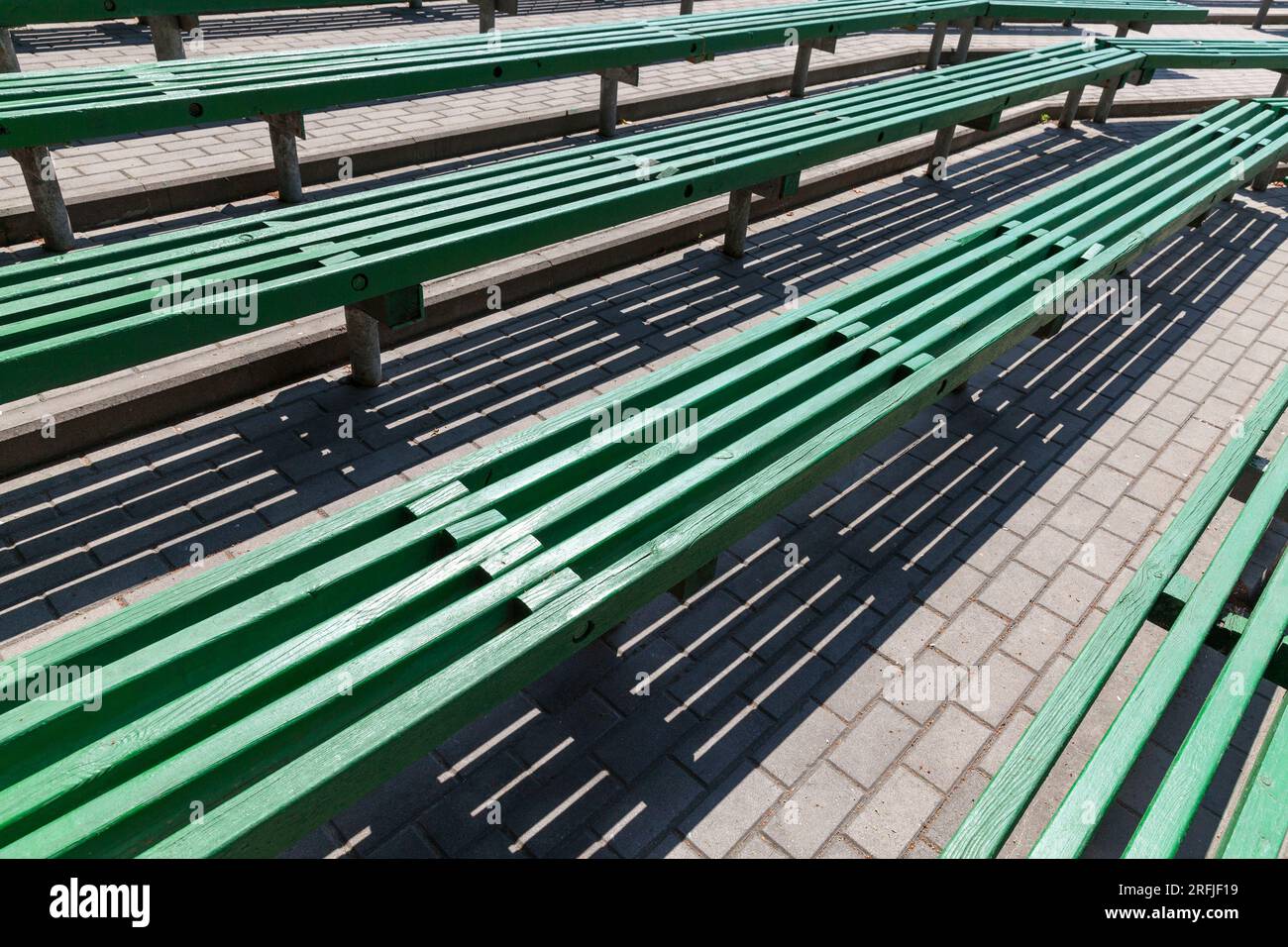 old wooden benches of green color, old benches located in a summer ...