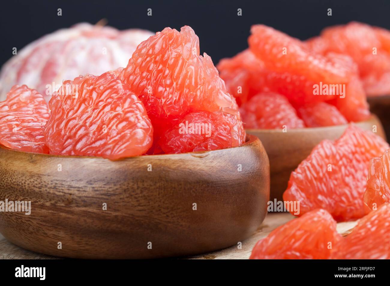 peeled pink grapefruit split into pieces while cooking, ready to eat ...