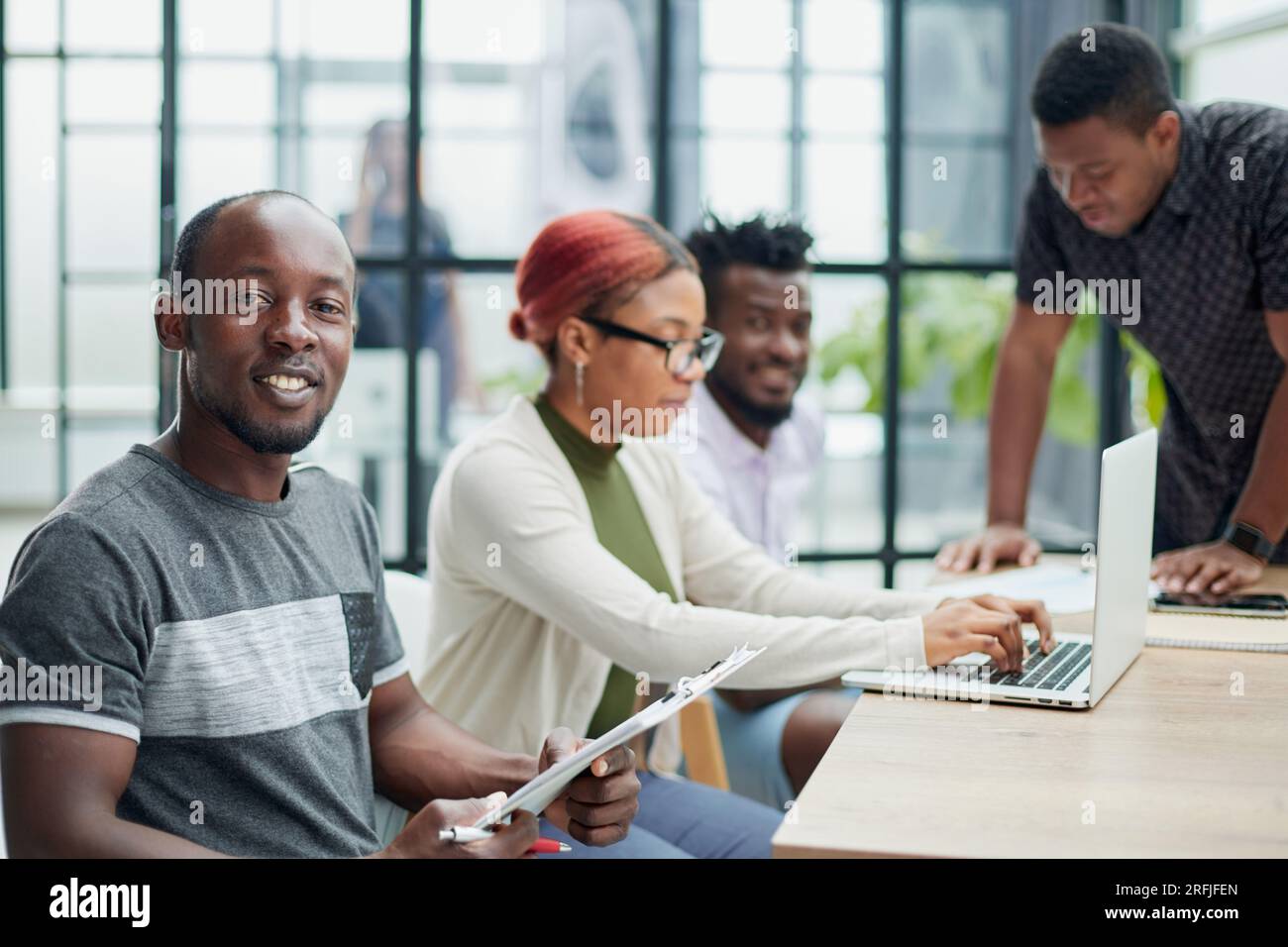 team of employees in a modern office at work. young african american ...
