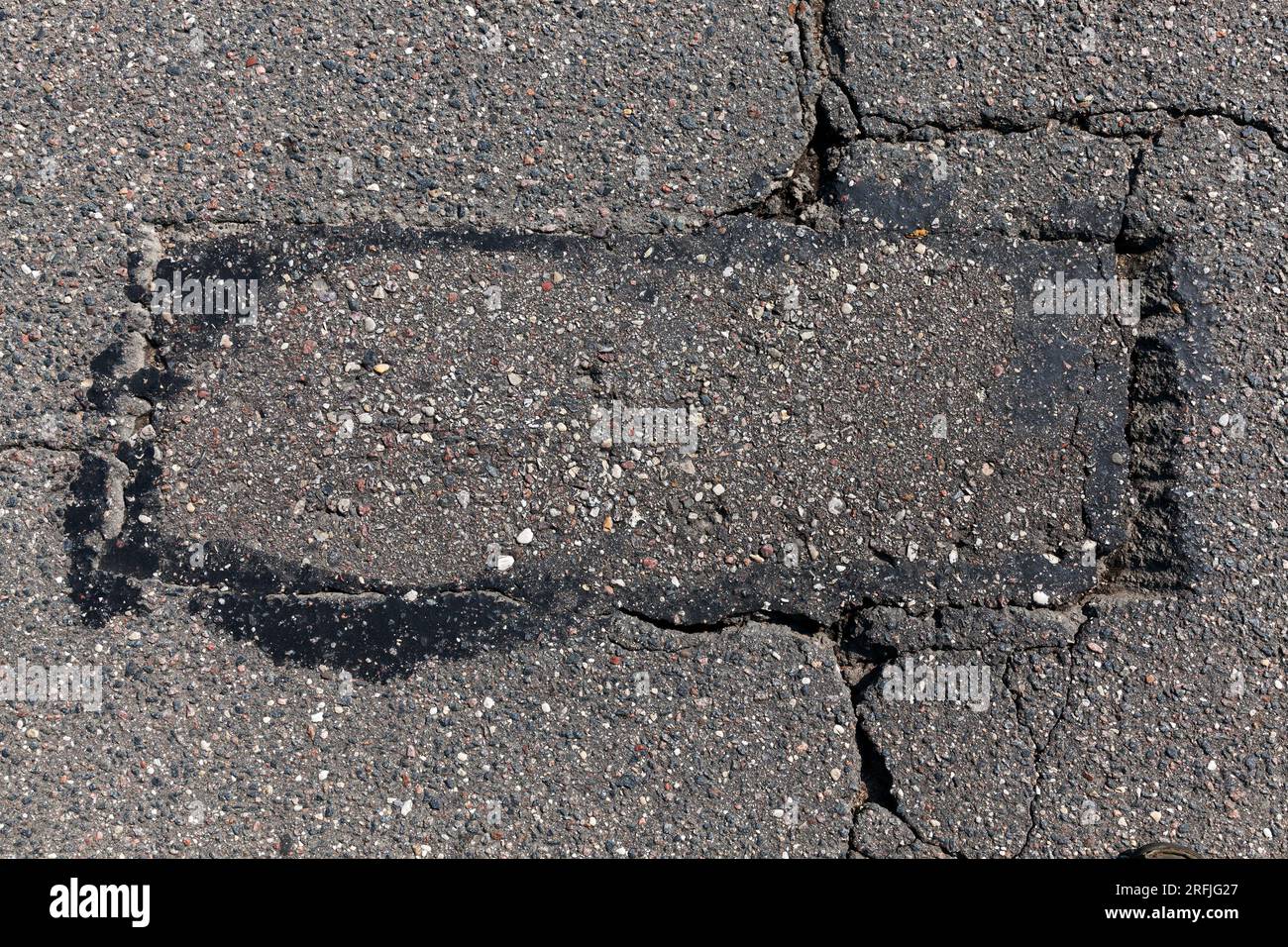an asphalt road with a lot of holes and damage, a poorly made ...