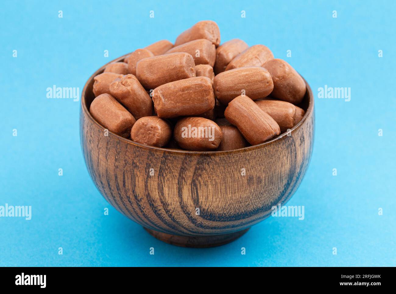 Pile of Freeze Dried Chocolate Candy Rolls Isolated on a Blue ...