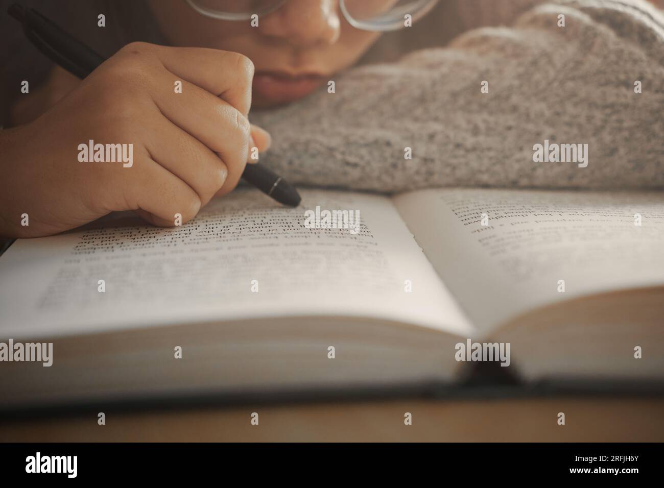 Boring student girl lying on book and reading book, Student girl at ...