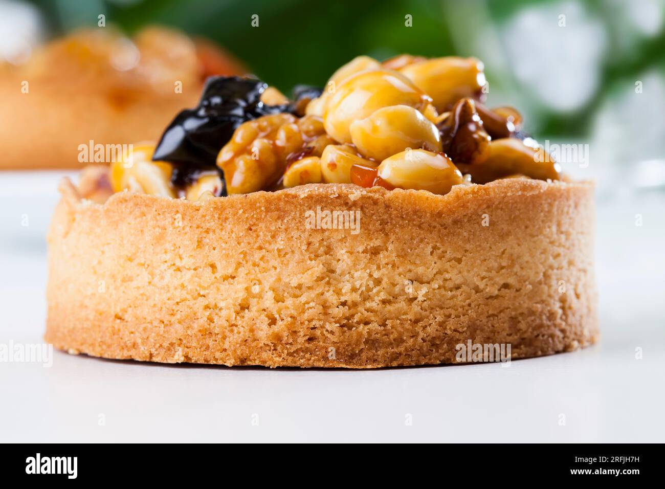 nut tartlets covered with a layer of sugar caramel, dessert of dough ...