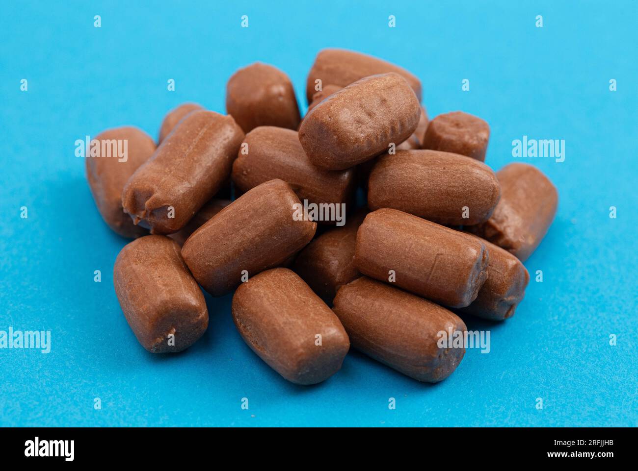Pile of Freeze Dried Chocolate Candy Rolls Isolated on a Blue ...