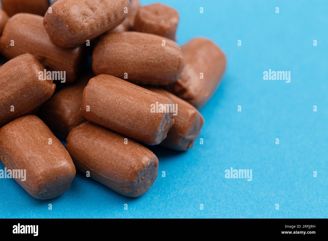 Pile of Freeze Dried Chocolate Candy Rolls Isolated on a Blue ...