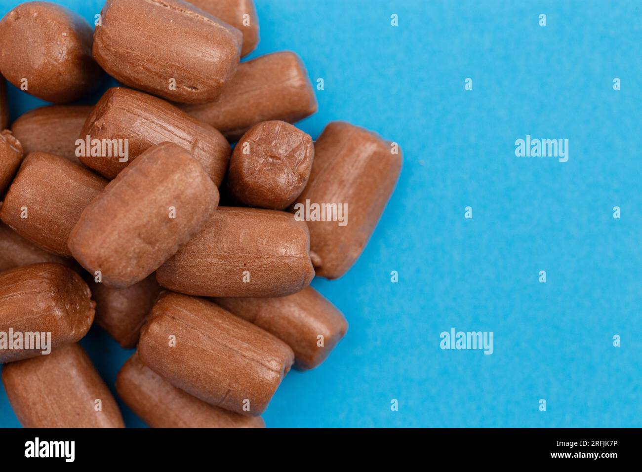 Pile of Freeze Dried Chocolate Candy Rolls Isolated on a Blue ...