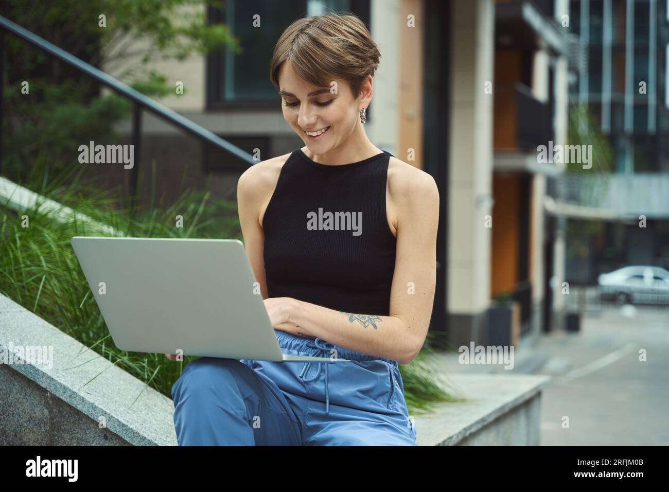 Female freelancer doing work tasks in urban environment Stock Photo - Alamy