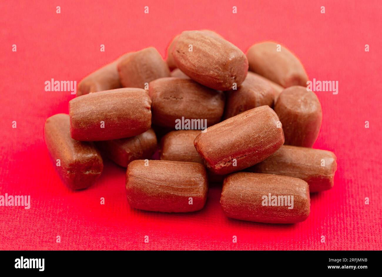A Pile of Freeze Dried Chocolate Candy Rolls Isolated on a Red ...