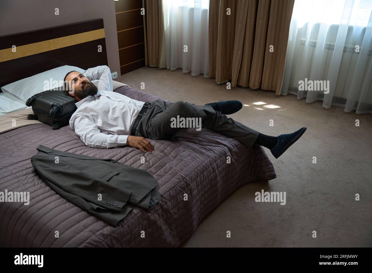 Bearded man lay down to rest from the road Stock Photo - Alamy