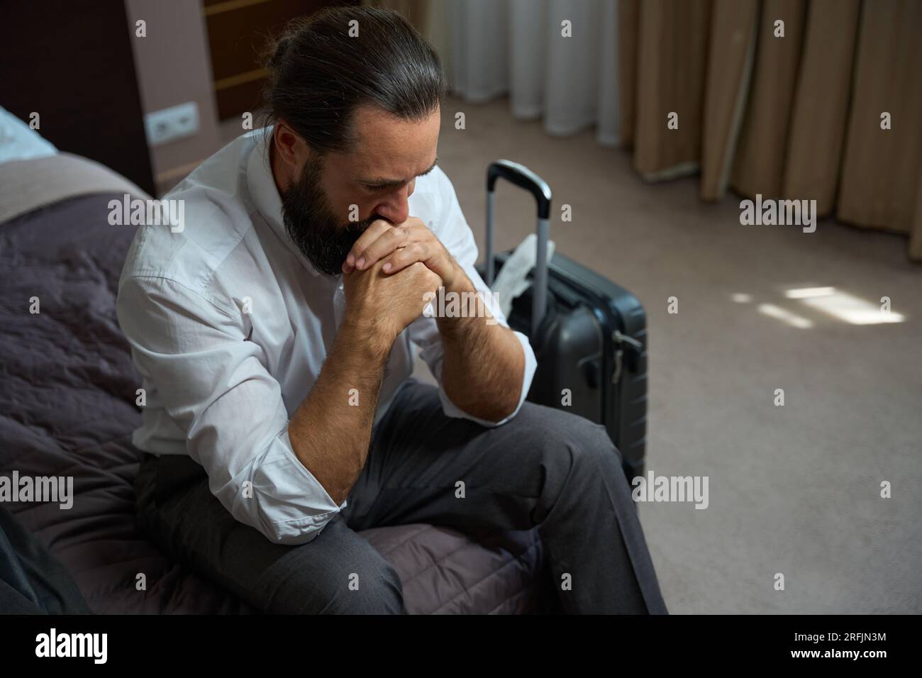 Middle-aged man sat down to rest in a hotel room Stock Photo - Alamy