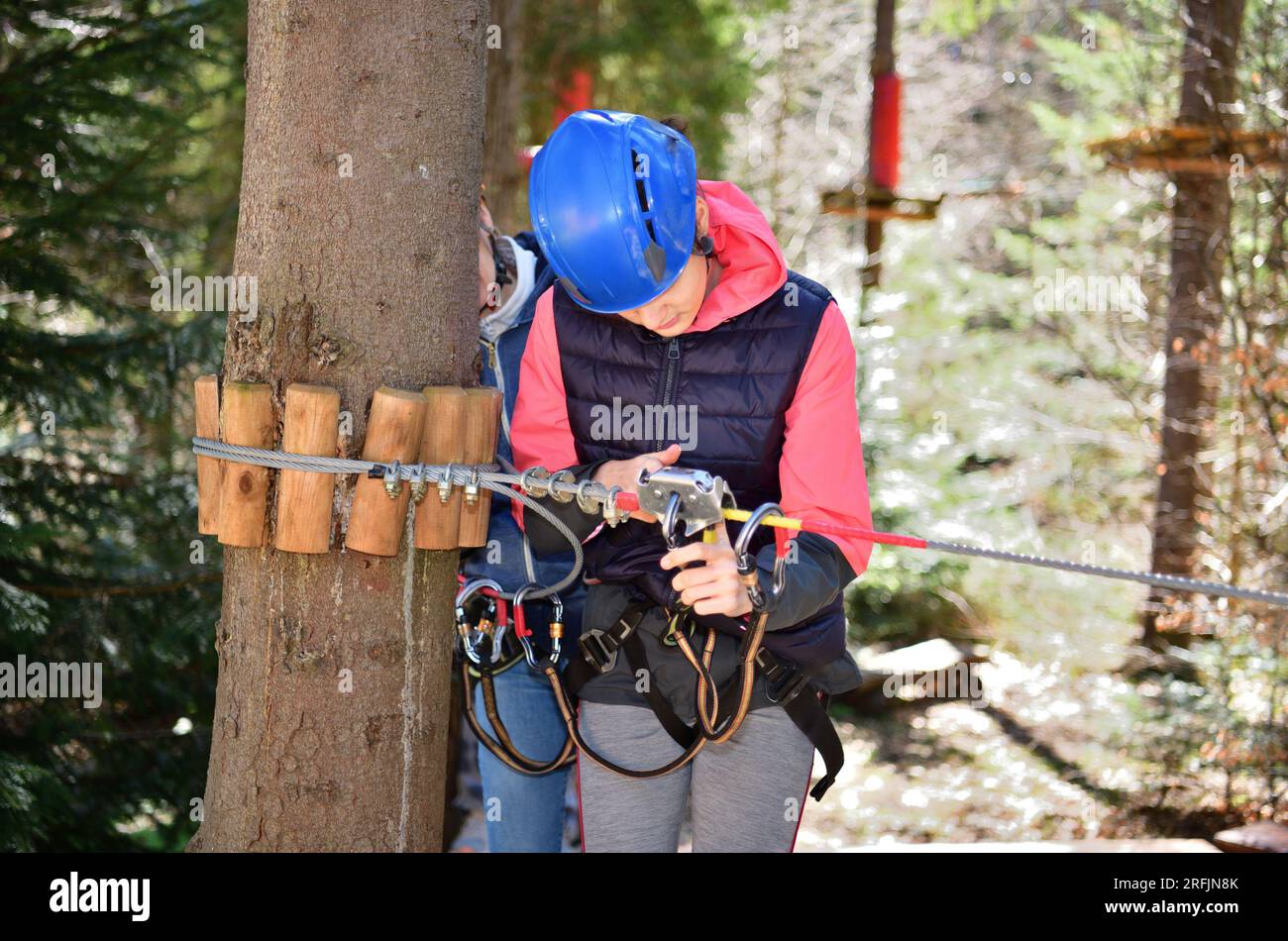 Young climber on the ropes checks the correct attachment of the safety ...