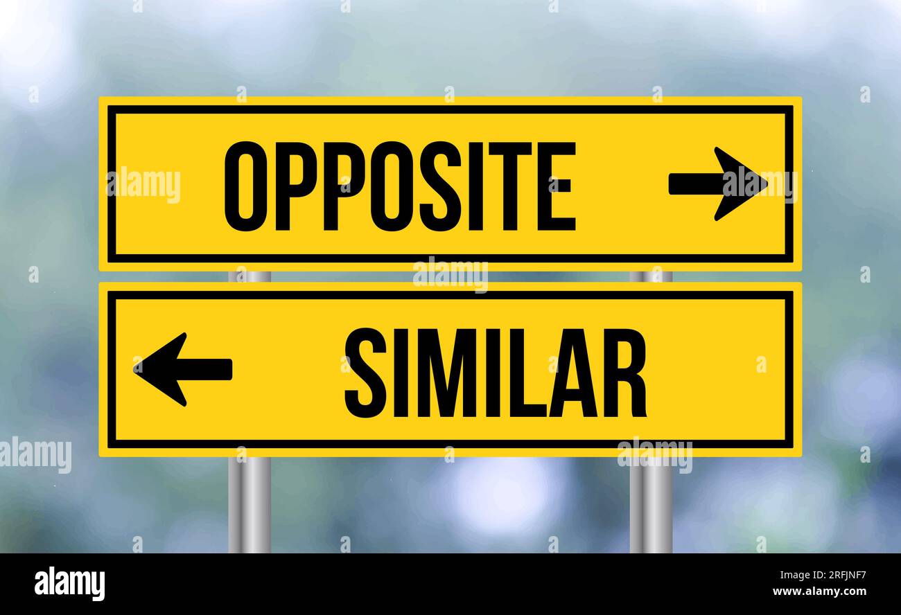 Opposite or similar road sign on blur background Stock Photo - Alamy