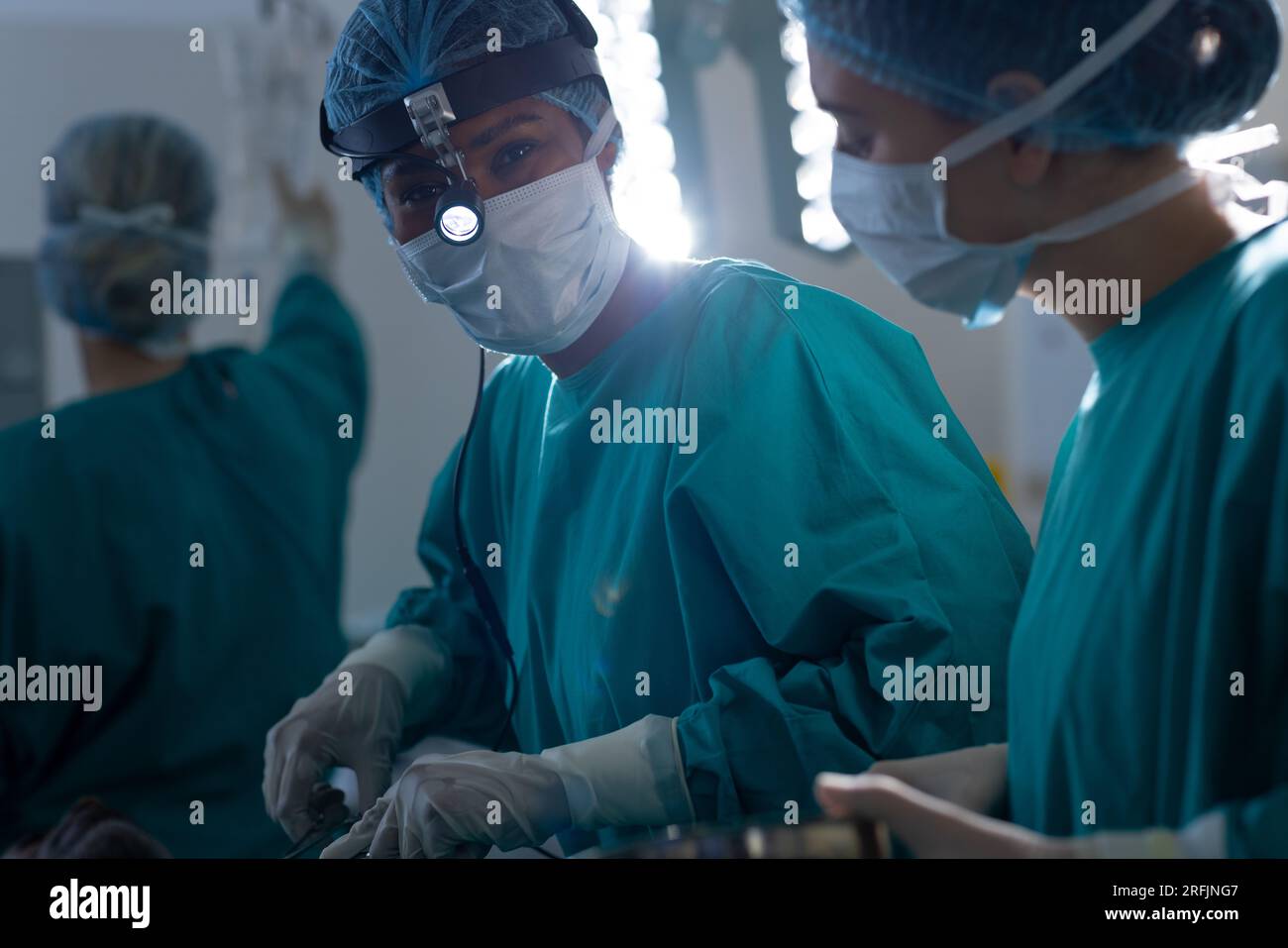 Portrait of african american female surgeon wearing surgical gown in ...