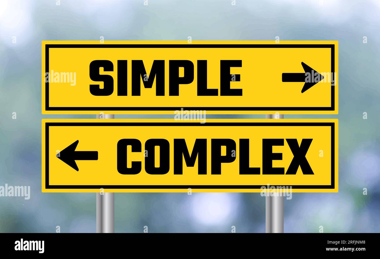 Simple or complex road sign on blur background Stock Photo - Alamy