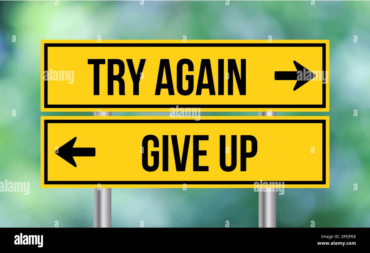 Try again or give up road sign on blur background Stock Photo - Alamy
