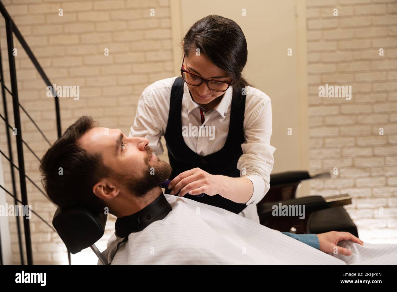 Professional barber cuts clients hair hi-res stock photography and ...