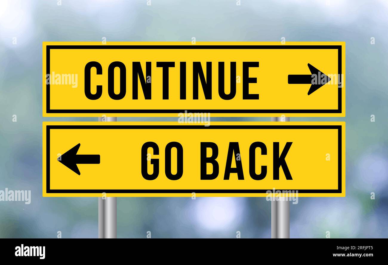 Continue or go back road sign on blur background Stock Photo - Alamy