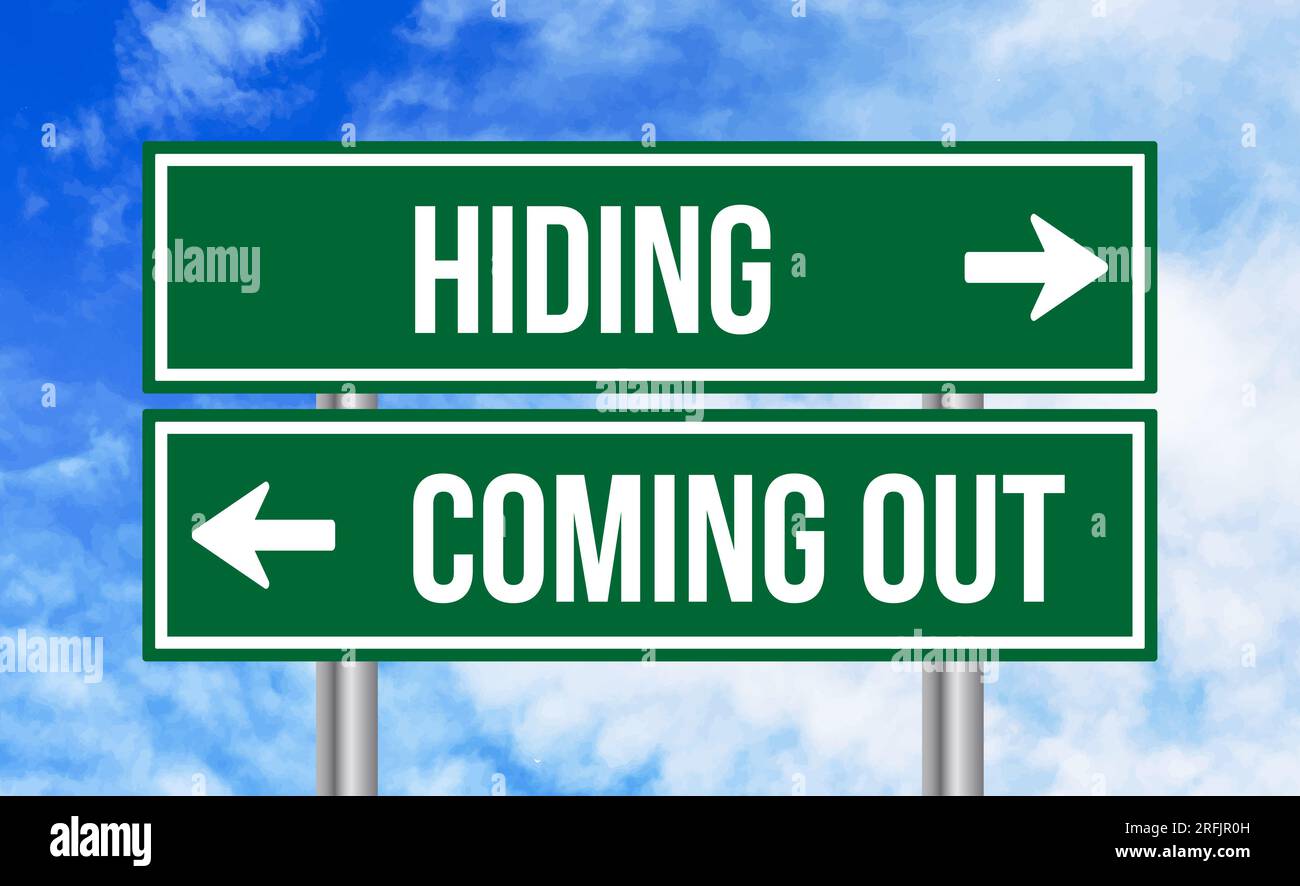 Hiding or coming out road sign on blue sky background Stock Photo - Alamy