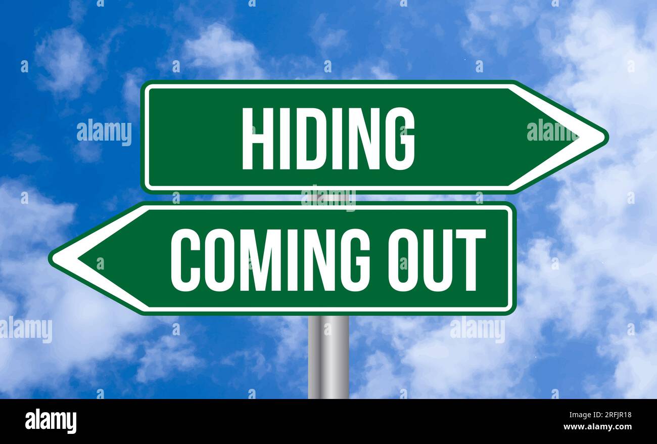 Hiding or coming out road sign on blue sky background Stock Photo - Alamy