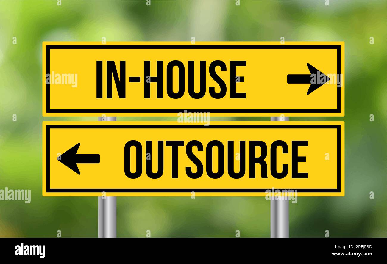 In house or outsource road sign on blur background Stock Photo - Alamy