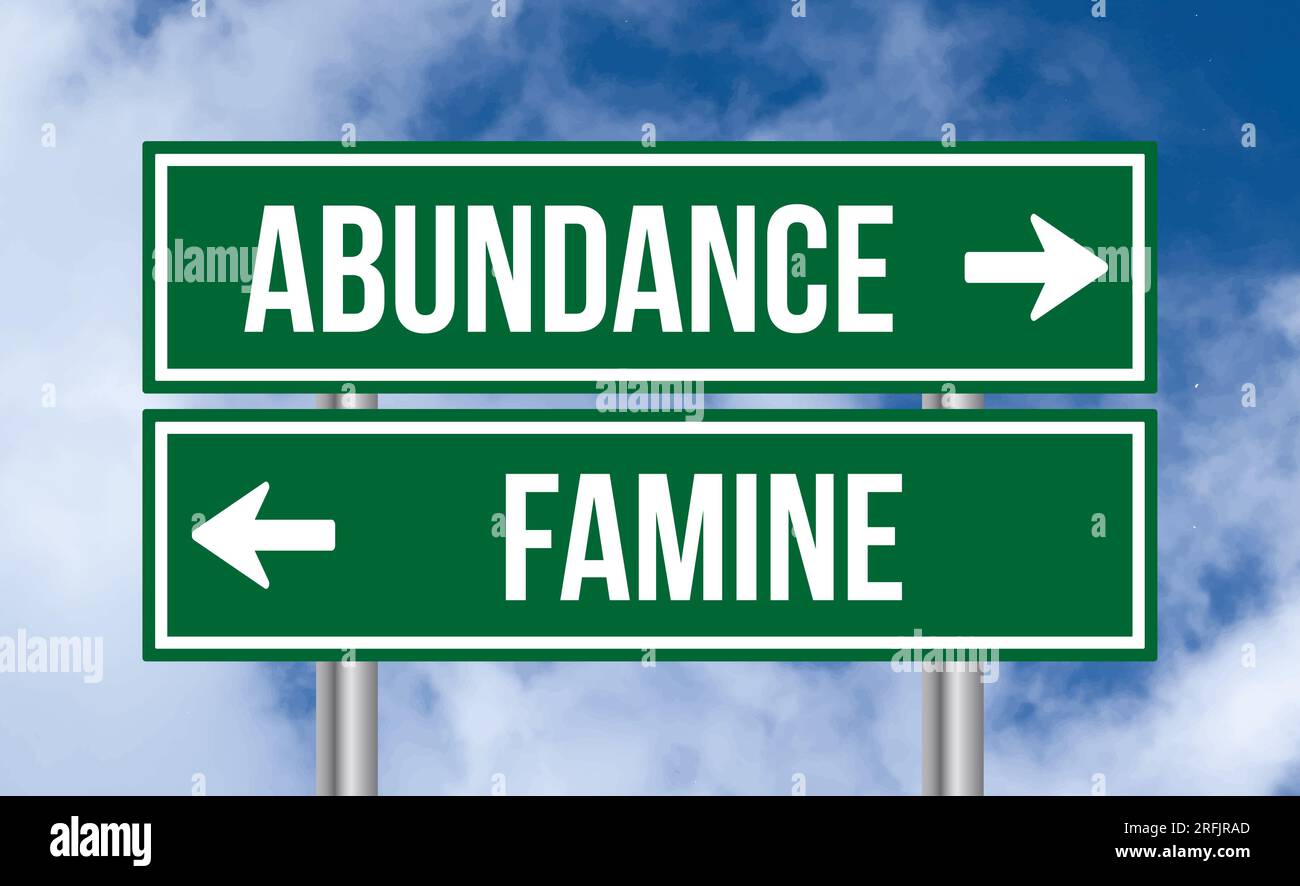 Abundance or famine road sign on blue sky background Stock Photo - Alamy