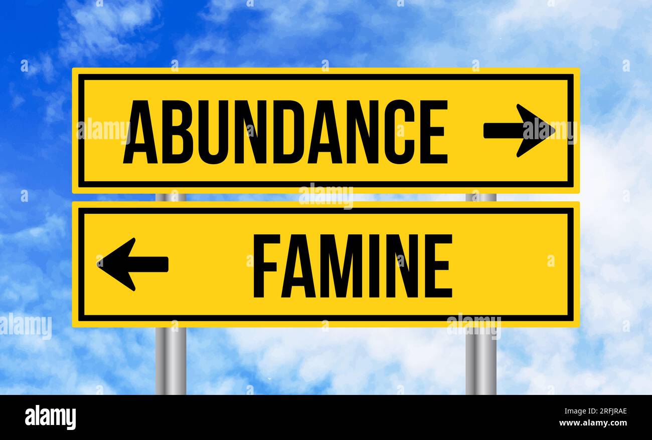 Abundance or famine road sign on blue sky background Stock Photo - Alamy