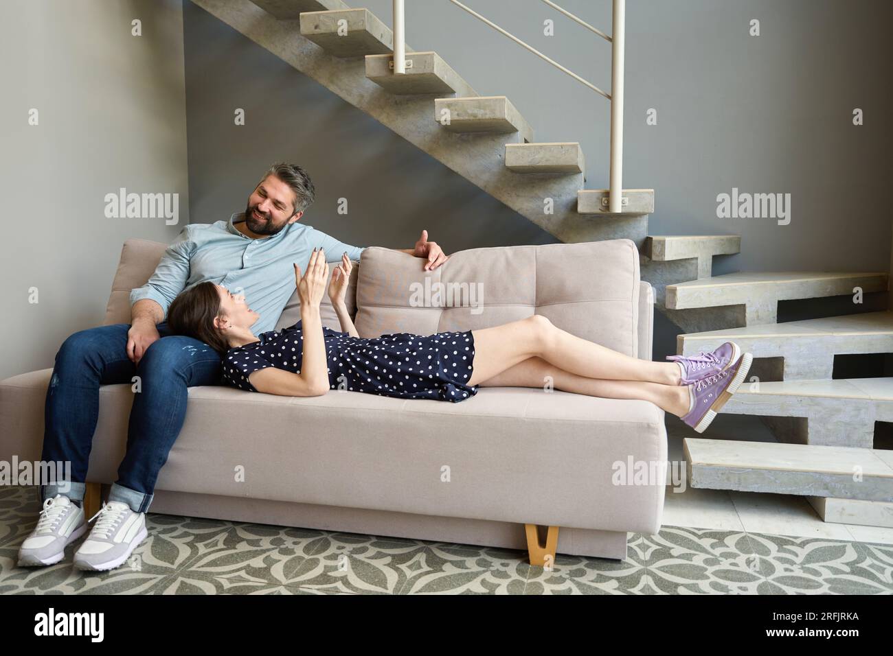 Man and a woman communicate warmly on a soft sofa Stock Photo - Alamy