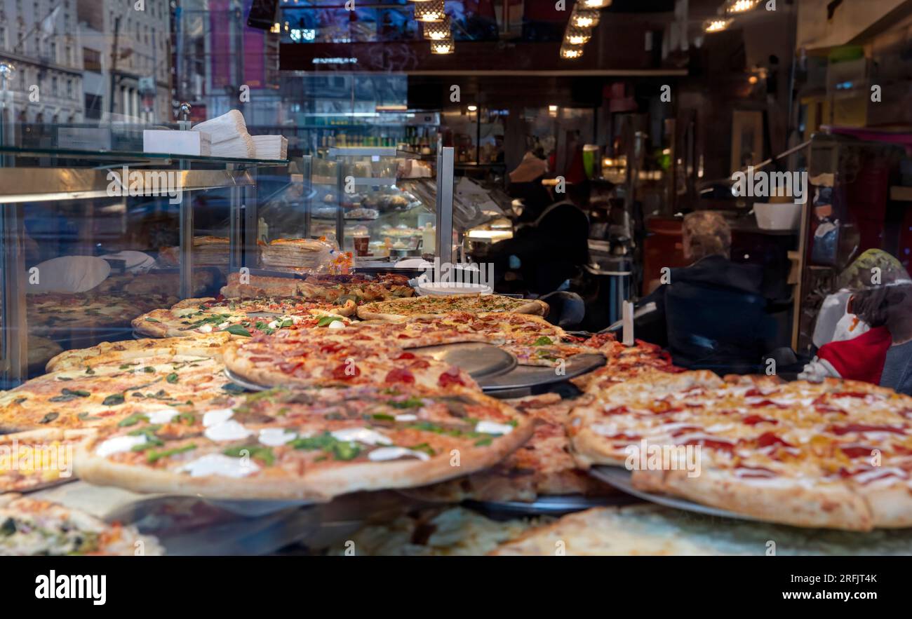 Pizza assortment in a pizza shop display, close up. Delicious Italian ...
