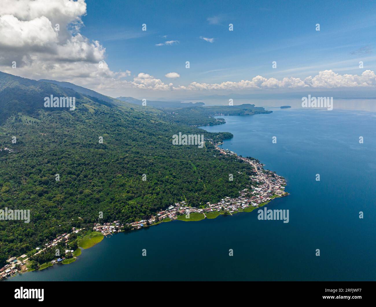 View of villages at lake coastline and mountain with jungle, forest ...