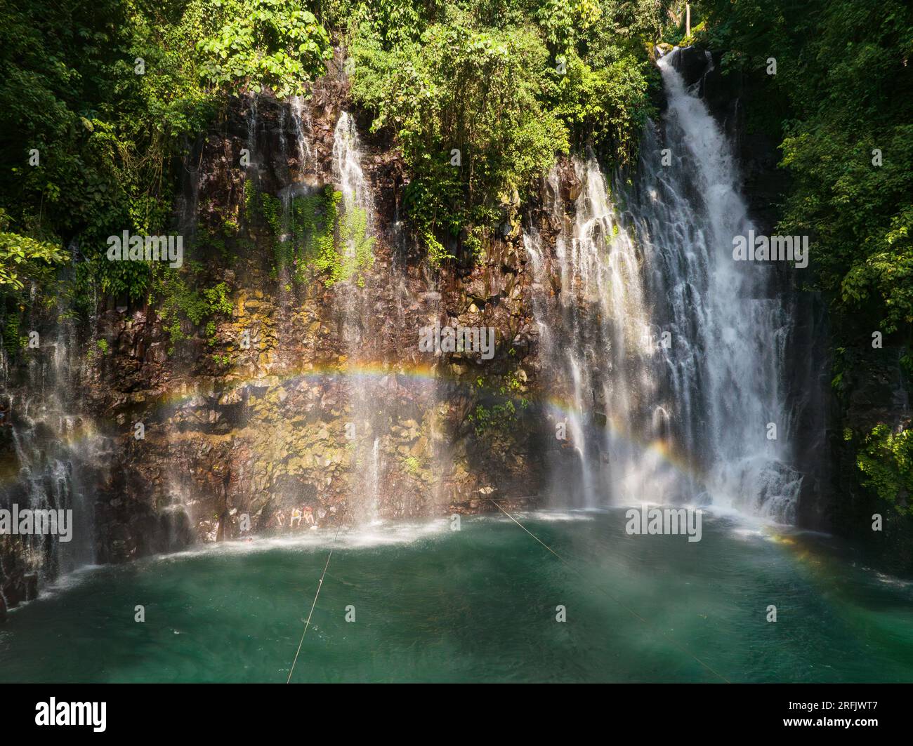 Tinago Falls with rainbow. Lanao del Norte. Mindanao, Philippines. Summer and travel concept ...