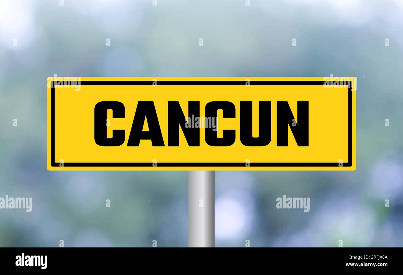 Cancun road sign on blur background Stock Photo - Alamy