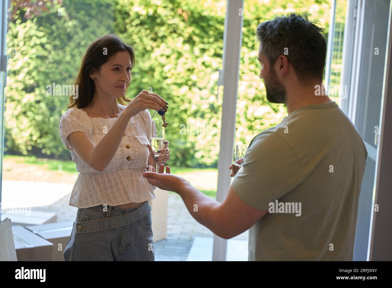Photo of loving couple standing at window Stock Photo - Alamy