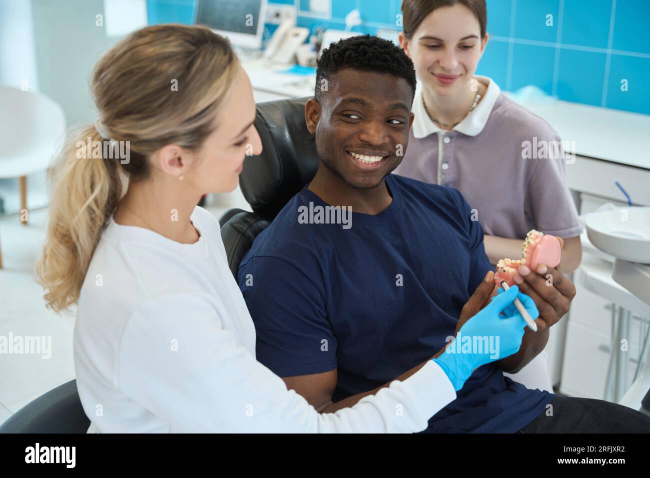 Smiling African American client satisfied with dental prosthetics way ...