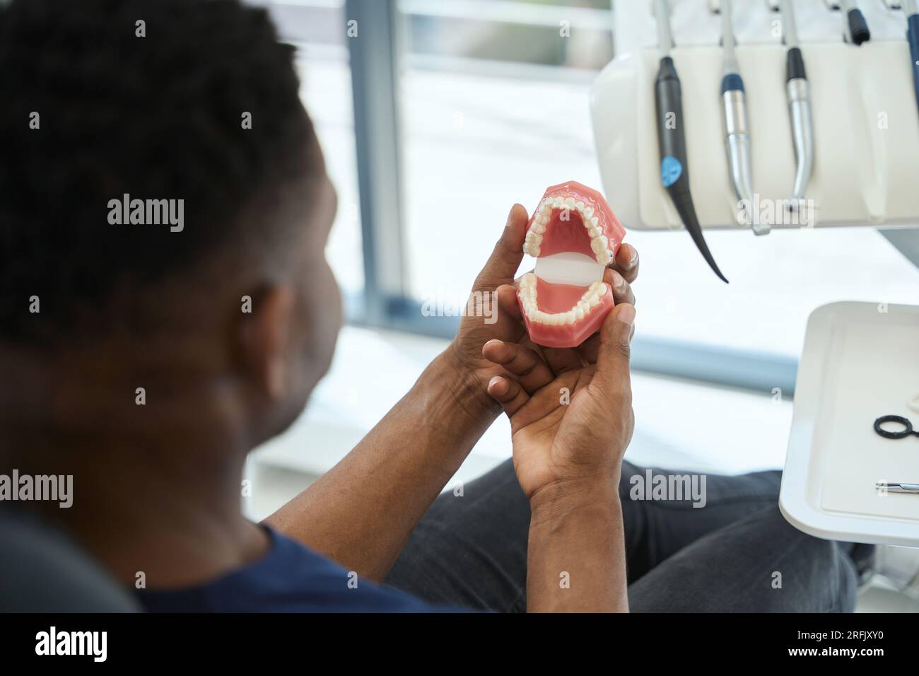 Male client of aesthetic stomatology clinic looking at 3d model of his ...
