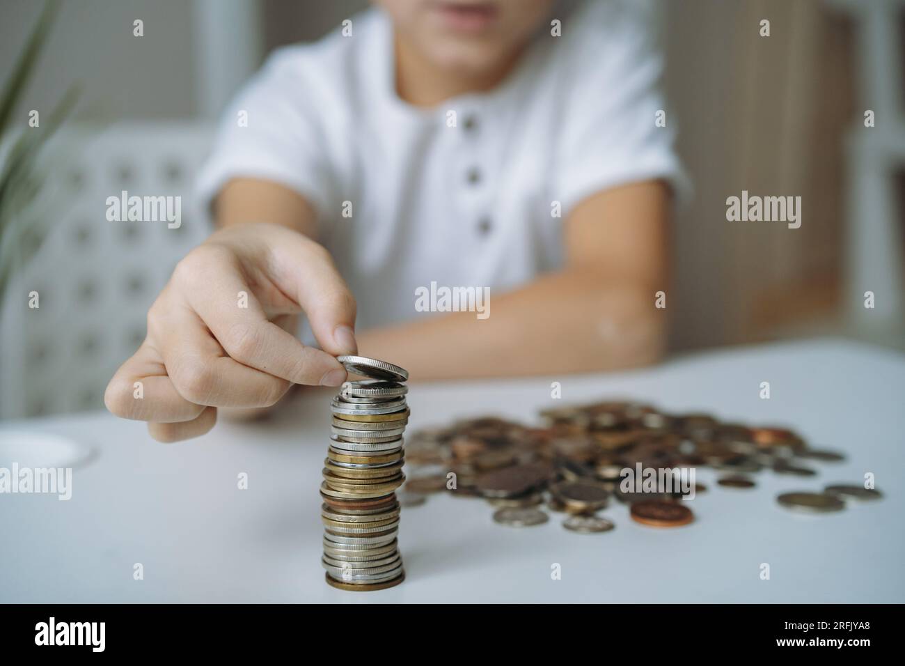 boy making pyramide of coins. ABC of finance. boy counting money. Image ...