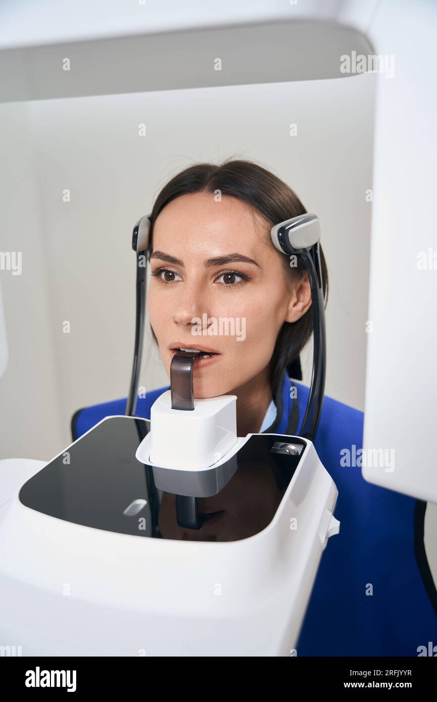 Charming lady undergoes 3D scanning procedures on modern equipment ...