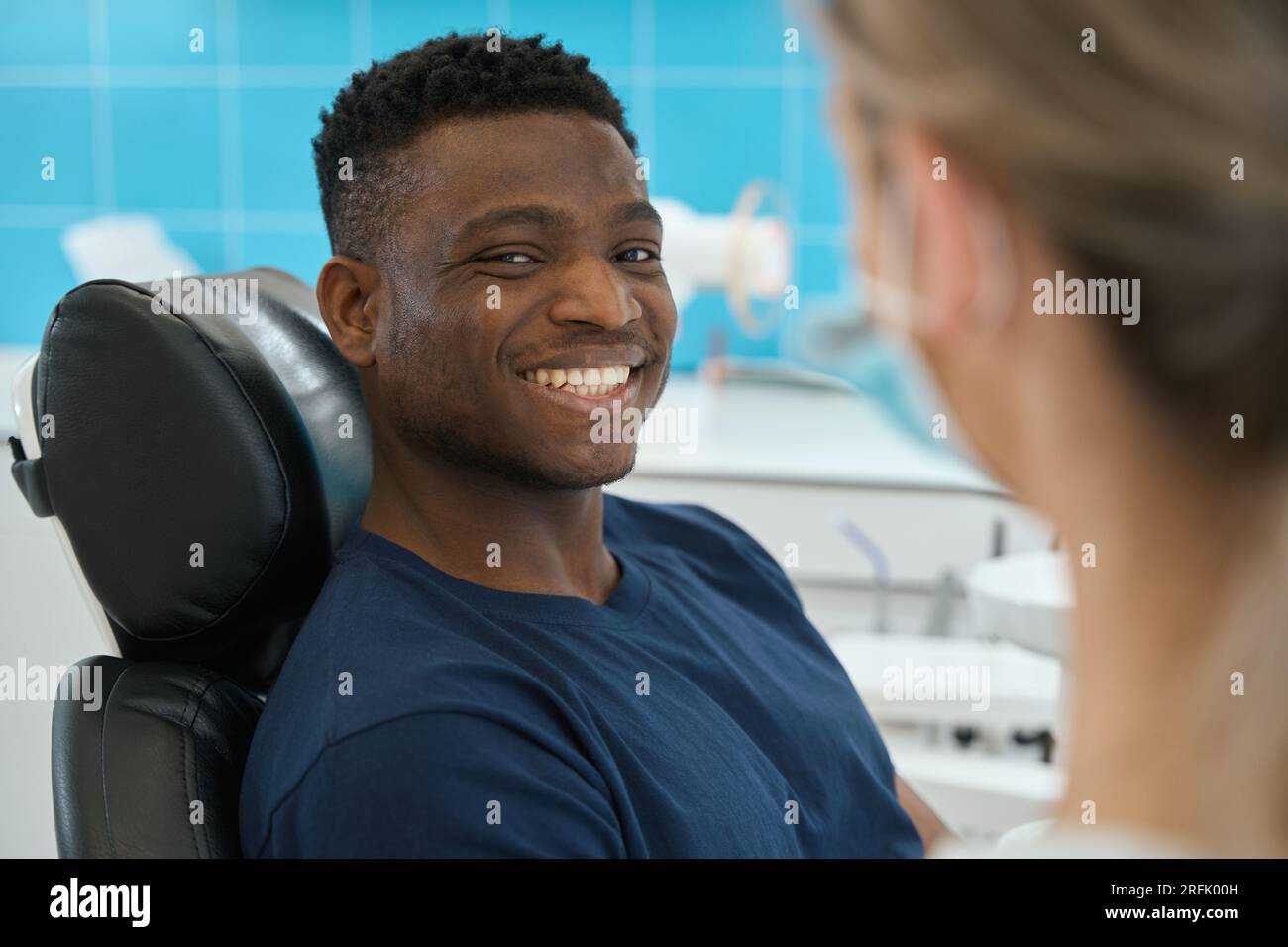 African American man smiling to camera showing healthy white teeth ...