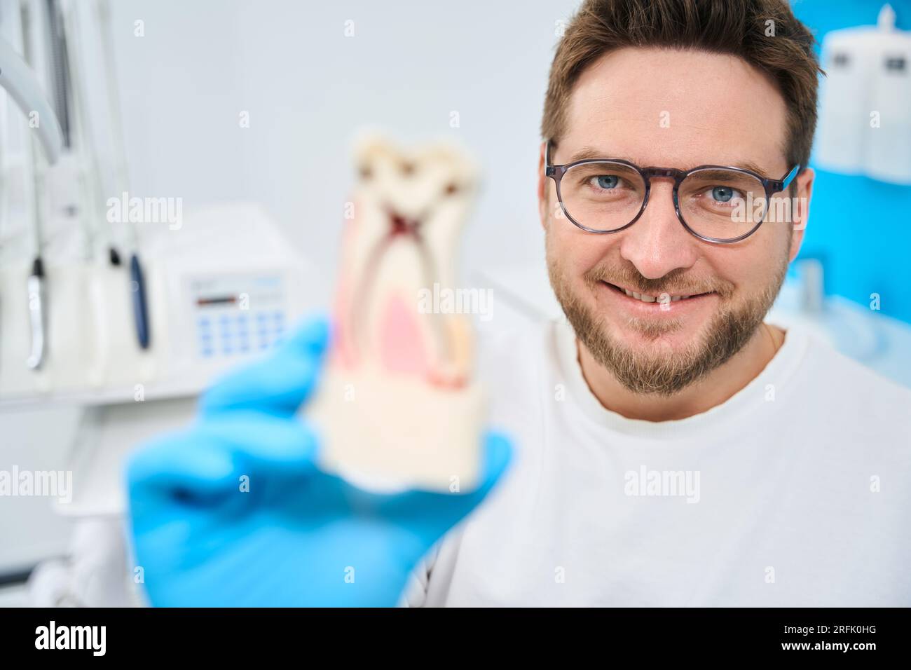 Stomatologist showing model of tooth, explaining way of treatment Stock ...