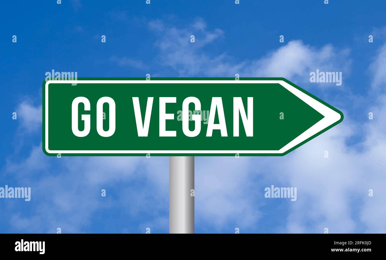 Go vegan road sign on cloudy sky background Stock Photo - Alamy
