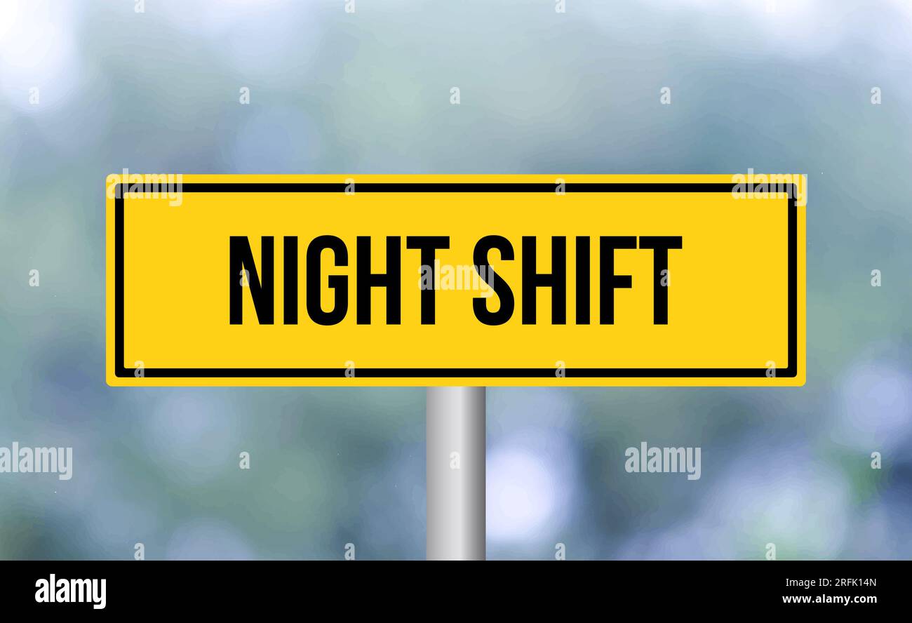 Night shift road sign on blur background Stock Photo - Alamy