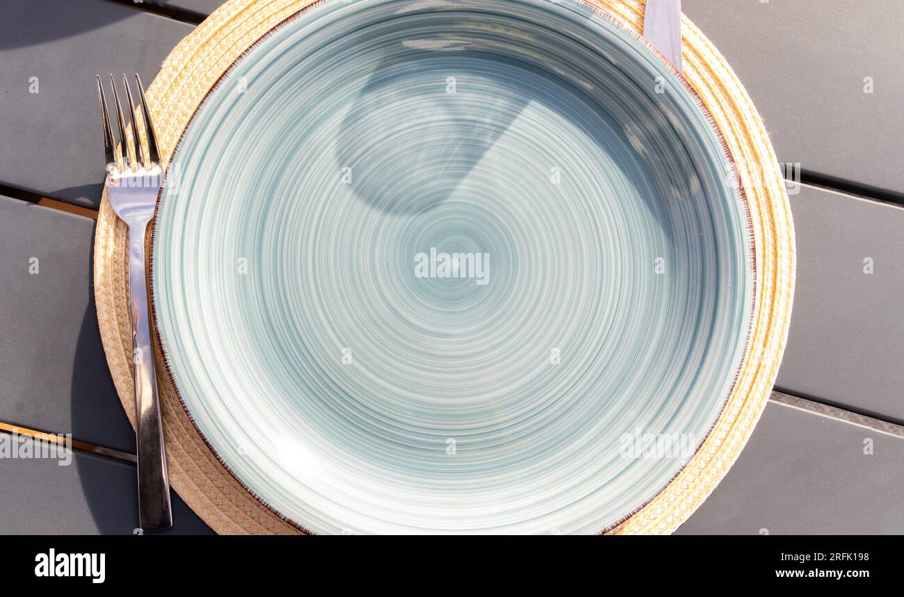 Empty plate, decorated with blue spiral, ready to serve dinner. Close ...
