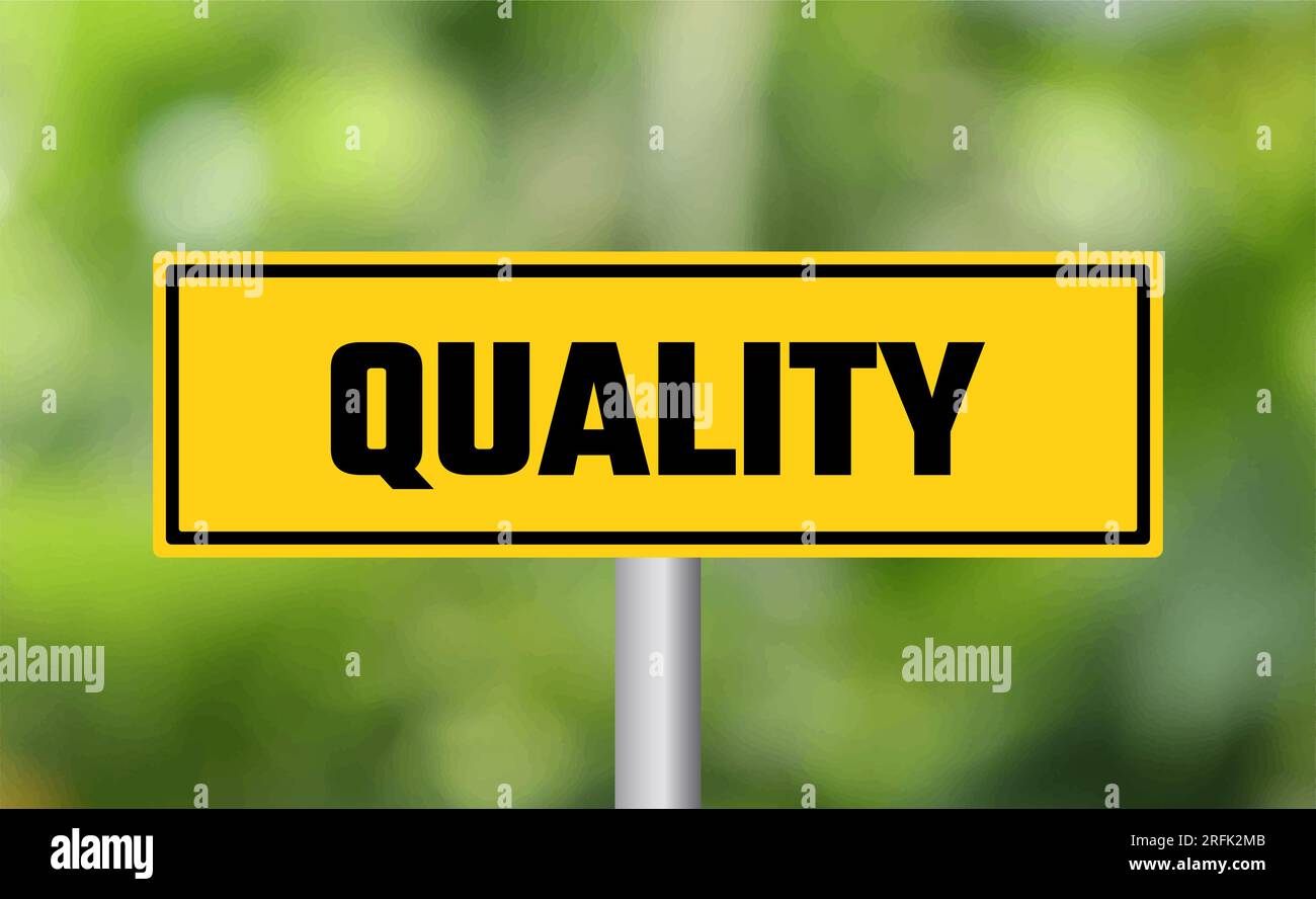 Quality road sign on blur background Stock Photo - Alamy