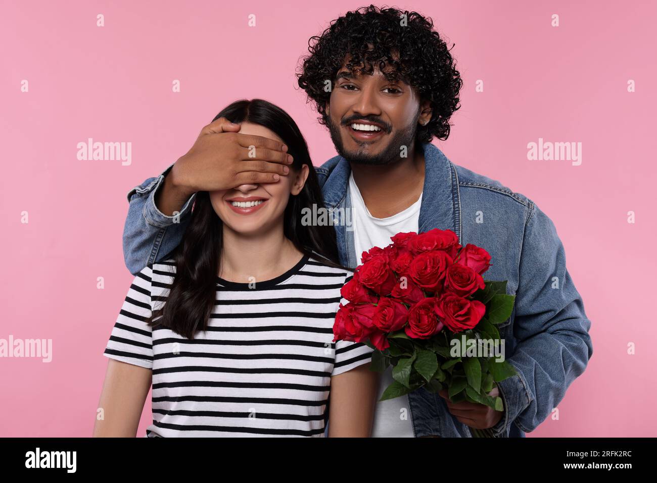 International dating. Handsome man presenting roses to his beloved ...
