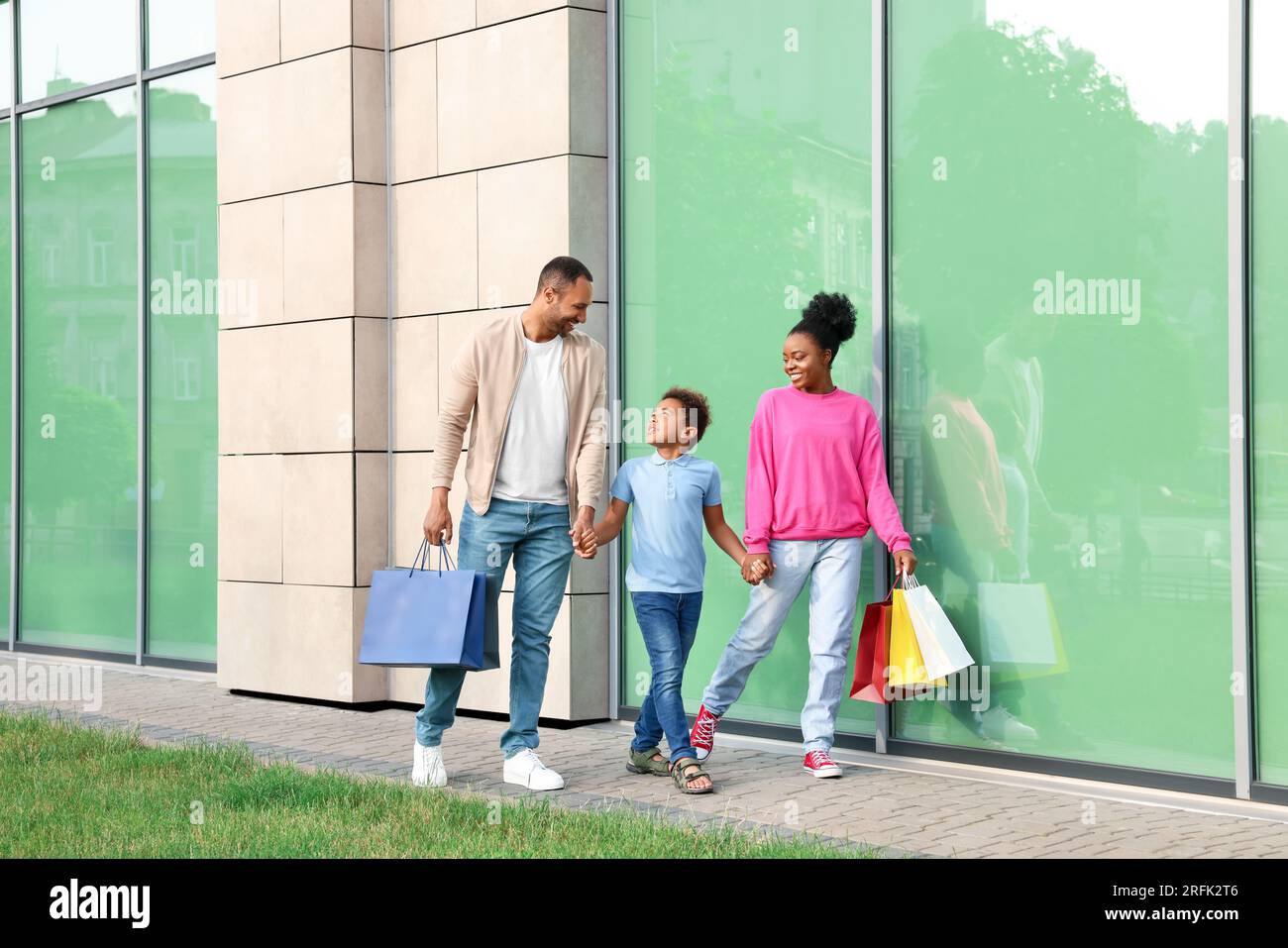 Family shopping. Happy parents and son with colorful bags near mall ...