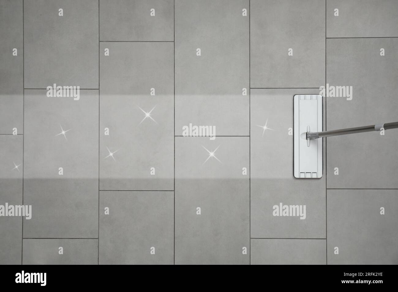 Washing floor with mop indoors, top view. Clean and shiny trace on ...