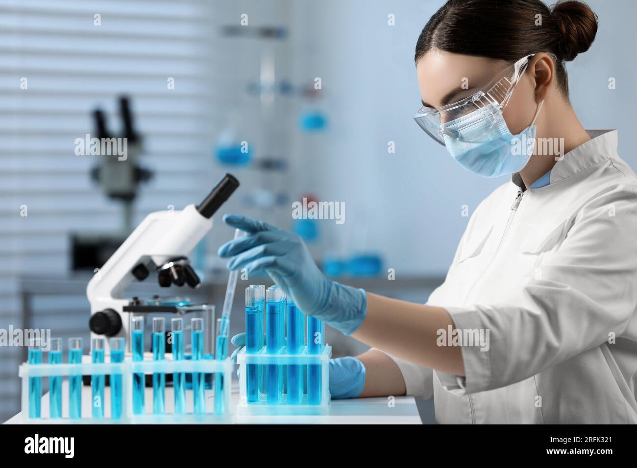 Scientist taking sample with dropper from test tube in laboratory Stock ...